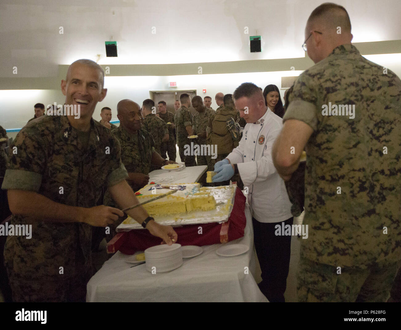 Col. David Odom serves cake during the 102nd birthday celebration for ...