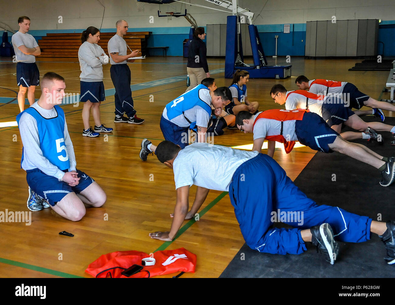 Physical training leaders watch as Airmen begin the push-up portion of ...