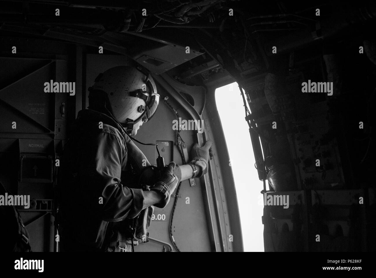 A Marine Corps V-22 Osprey crew member helps transport Secretary of ...