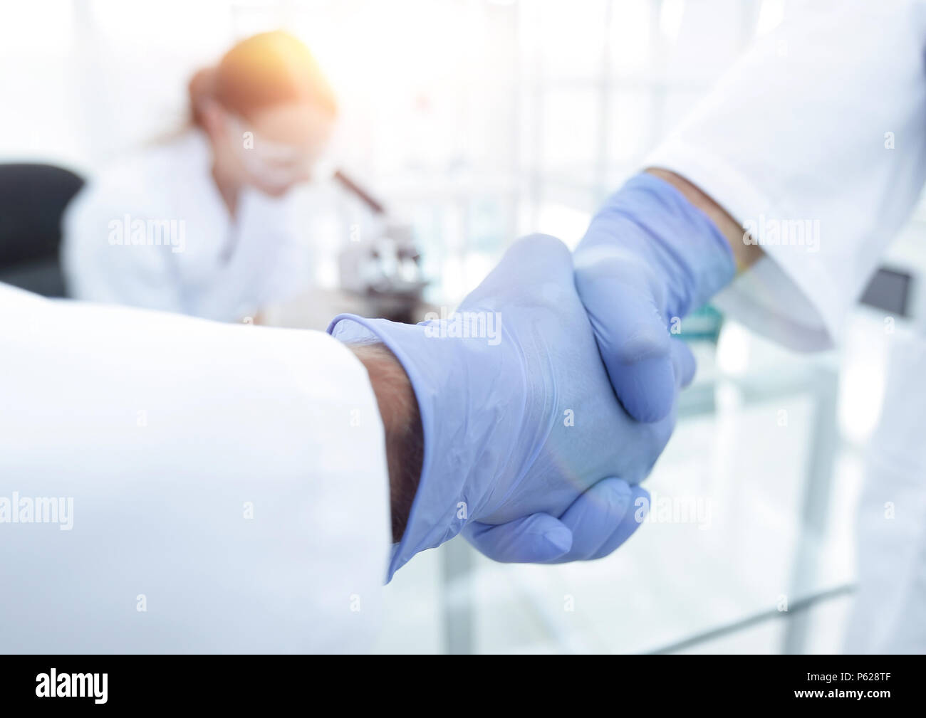 hand in the medical glove (handshake Stock Photo - Alamy