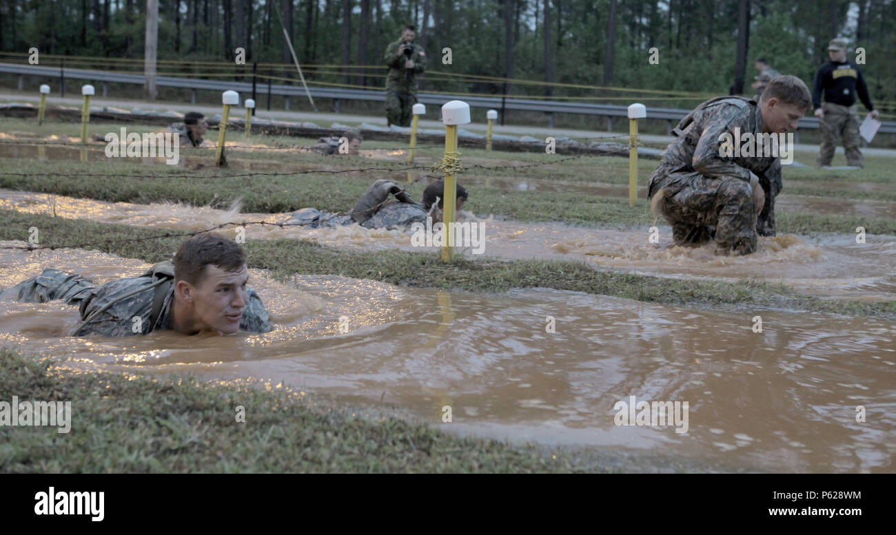 U.S. Army Soldiers low crawl through an obstacle during the Best Ranger ...