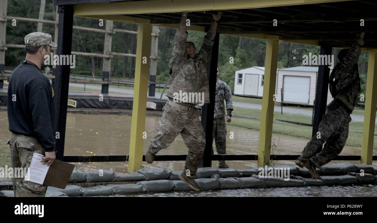 U.S. Soldiers climb through an obstacle at the Malvesti Obstacle Course ...