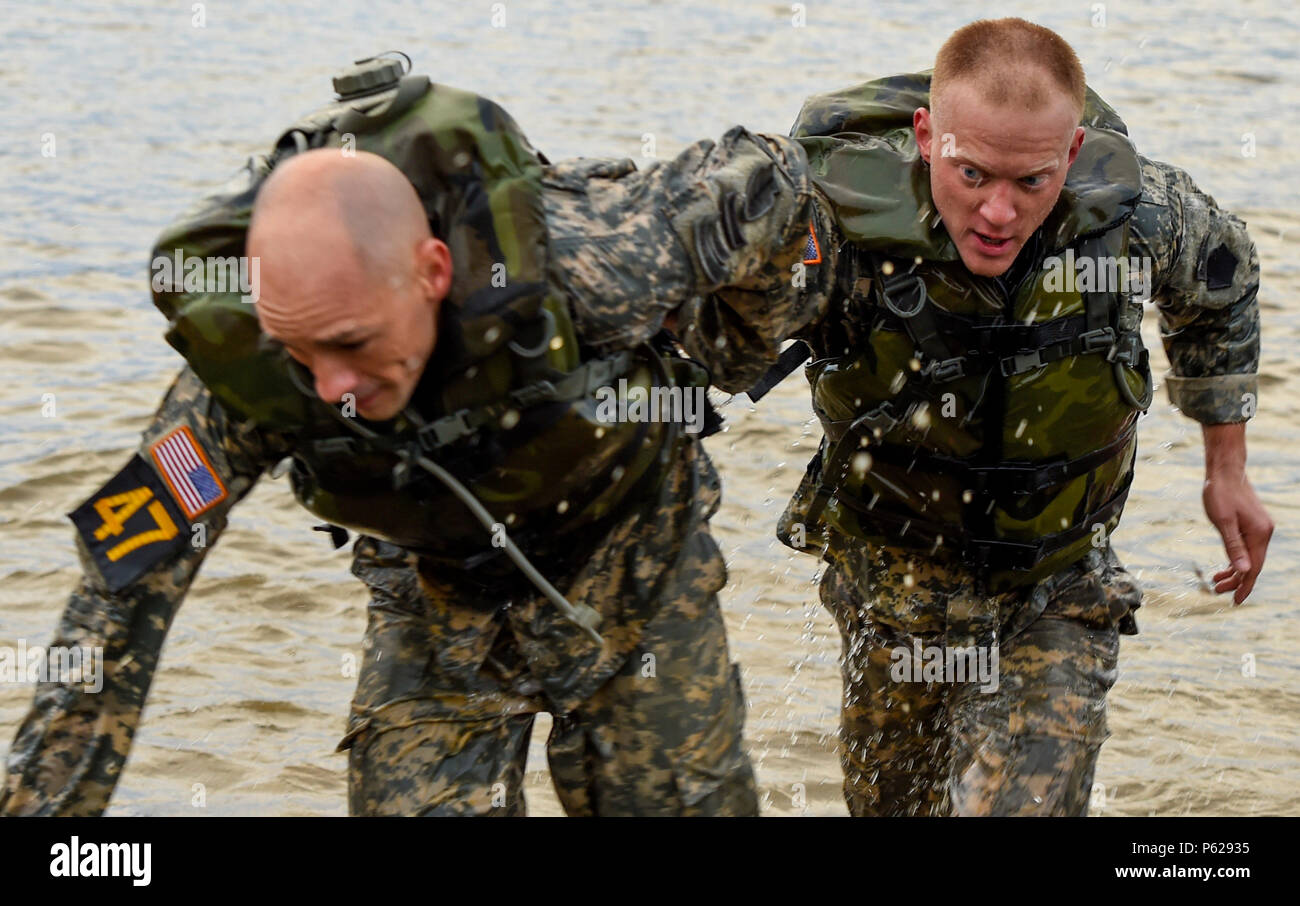 U.S. Army Capt. Robert Killian helps Staff Sgt. Erich Friedlein ...