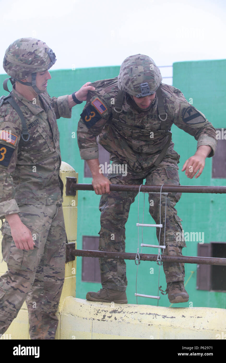 U.S. Army Capt. James Teskey assists his teammate, 1st Lt. Nicholas ...