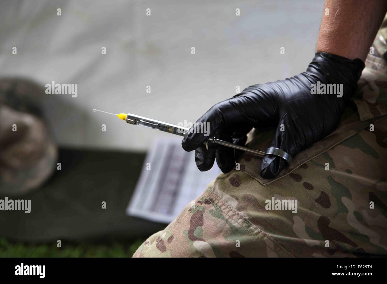 U.S. Army Col John Kohl prepares needle to numb the patients mouth at ...