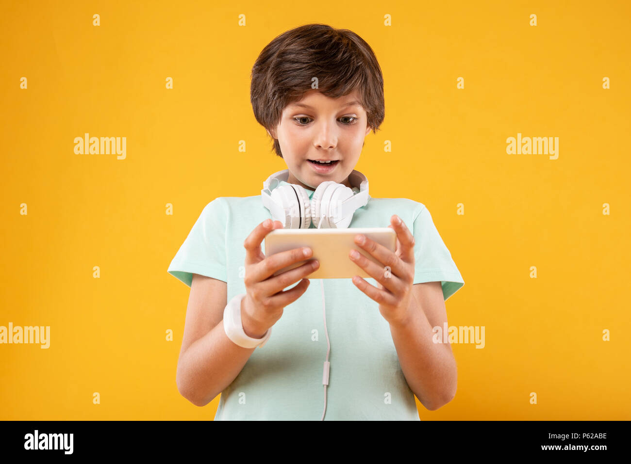 Inspired boy using his modern phone Stock Photo - Alamy