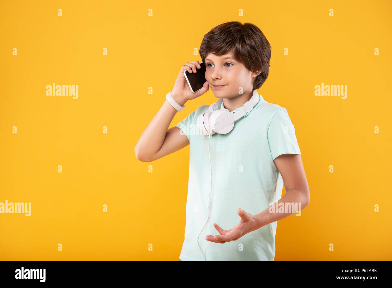 Alert child talking on the phone Stock Photo - Alamy