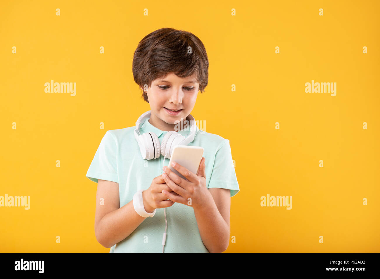 Content boy using his modern phone Stock Photo - Alamy