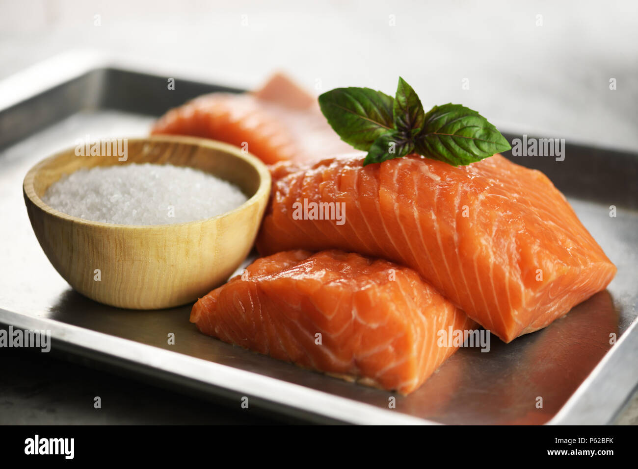Fillet of salmon fish on metal plate closeup Stock Photo - Alamy