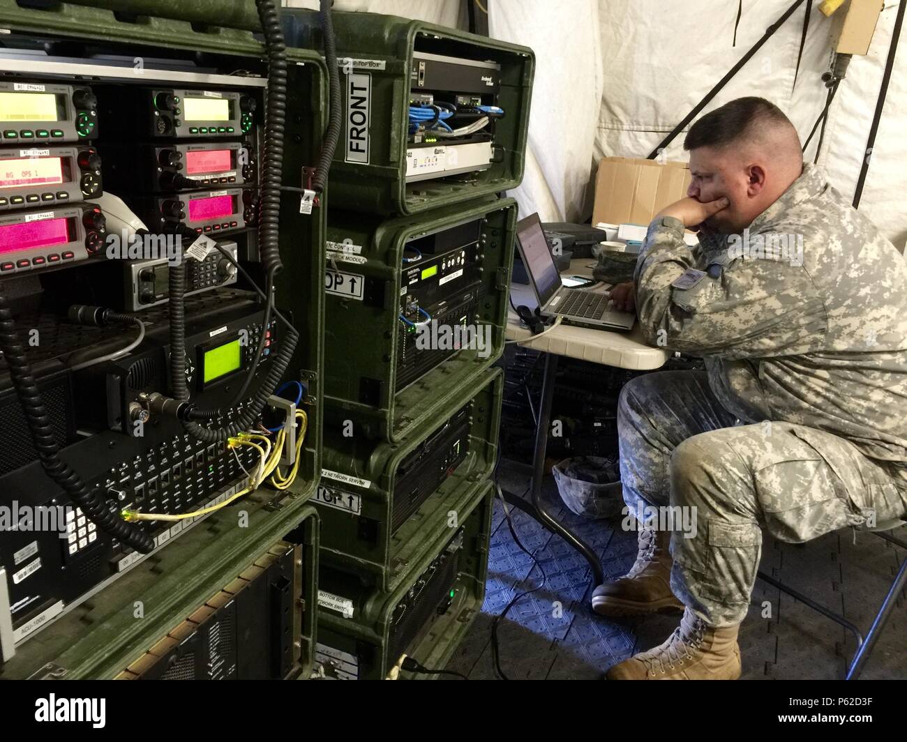 Sgt. Joshua Bonachea monitors connections to the Joint Incident Site ...