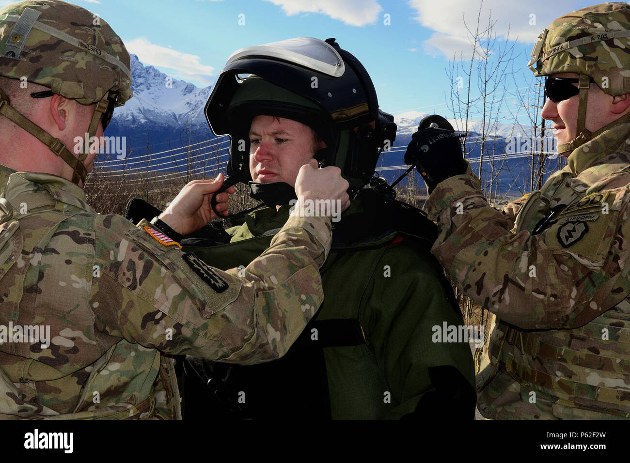 Cpl. Joshua Lackey (left) and Spc. Matthew Fannon help Sgt. Richard Harvey, 716th Ordnance ...