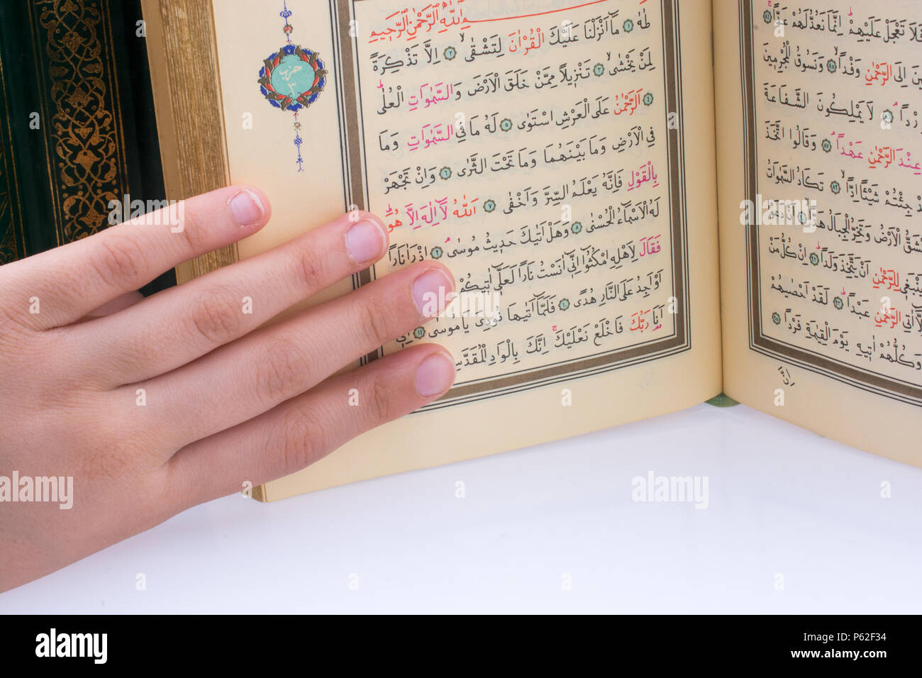 Hand holding The Holy Quran on a white background Stock Photo - Alamy