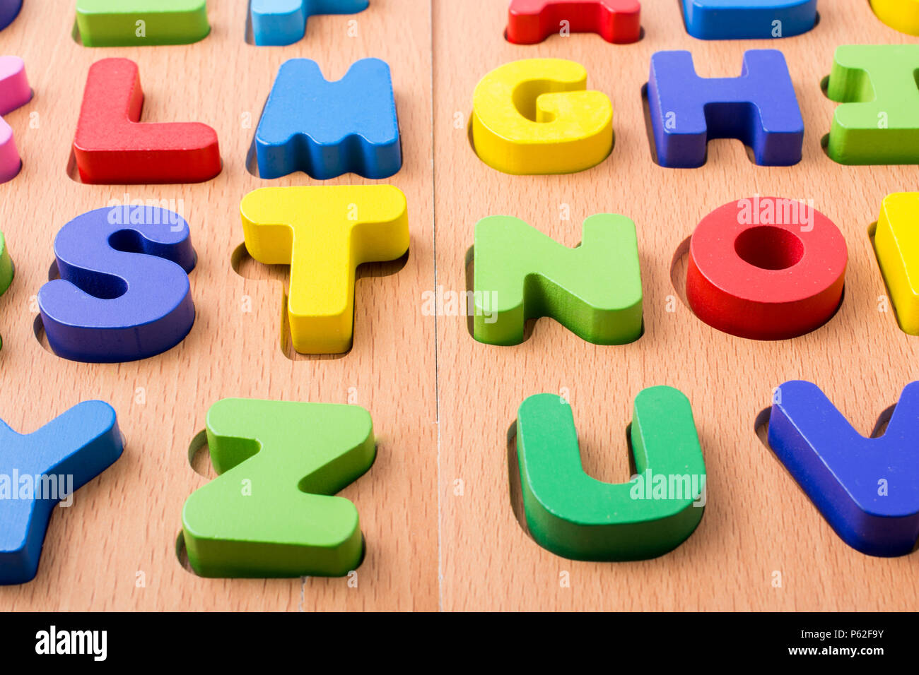 Colorful letter blocks on board on white background Stock Photo - Alamy