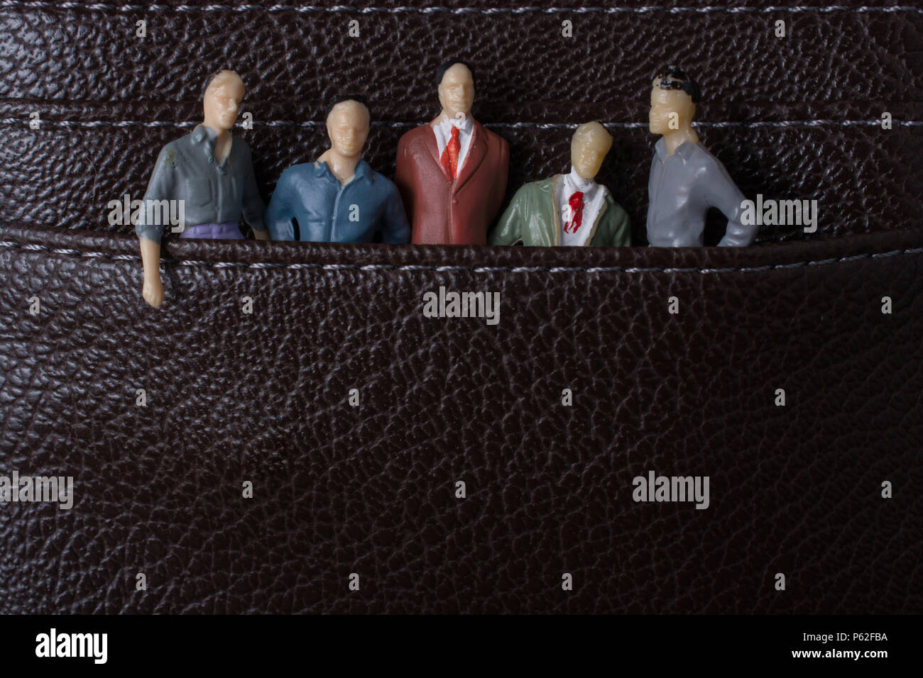 Tiny figurine of group of men miniature model in pockets Stock Photo ...