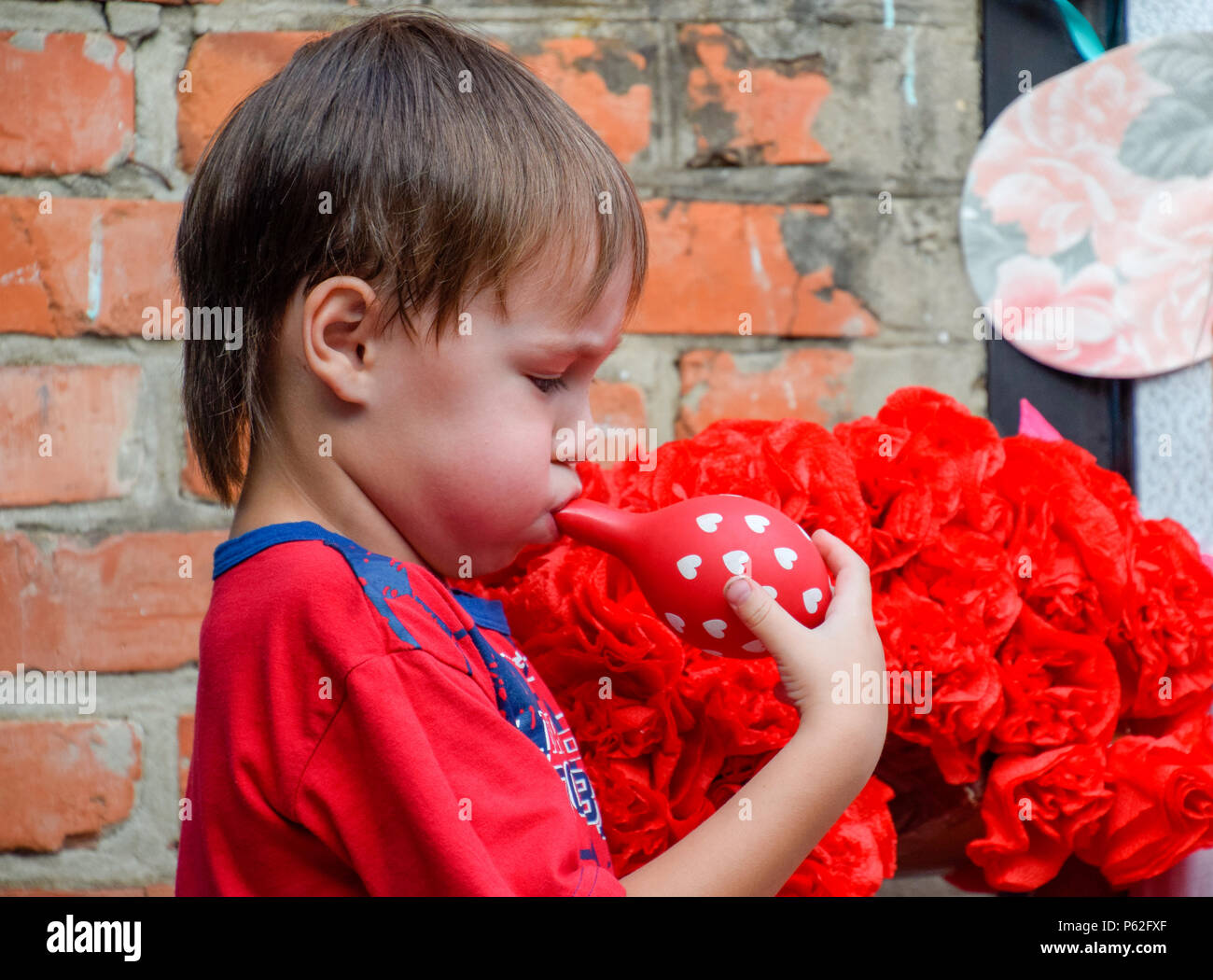 Boy blowing up balloon hi-res stock photography and images - Alamy