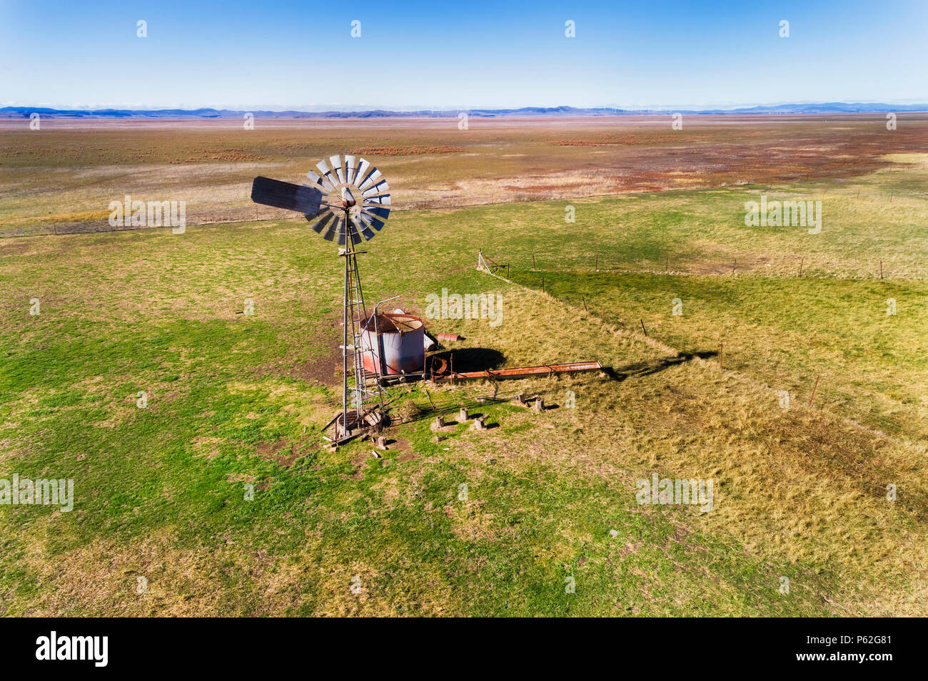 Old rusty windmill on a remote cattle ship farm on dry plains of Lake ...