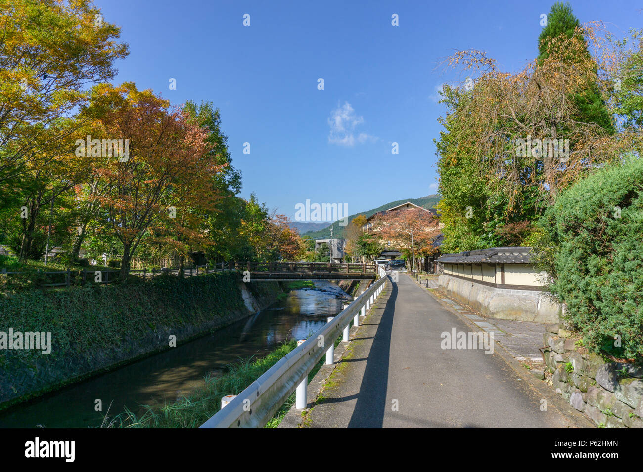 The road to Kinrin Lake with Mount Yufu in Background and blue sky with ...