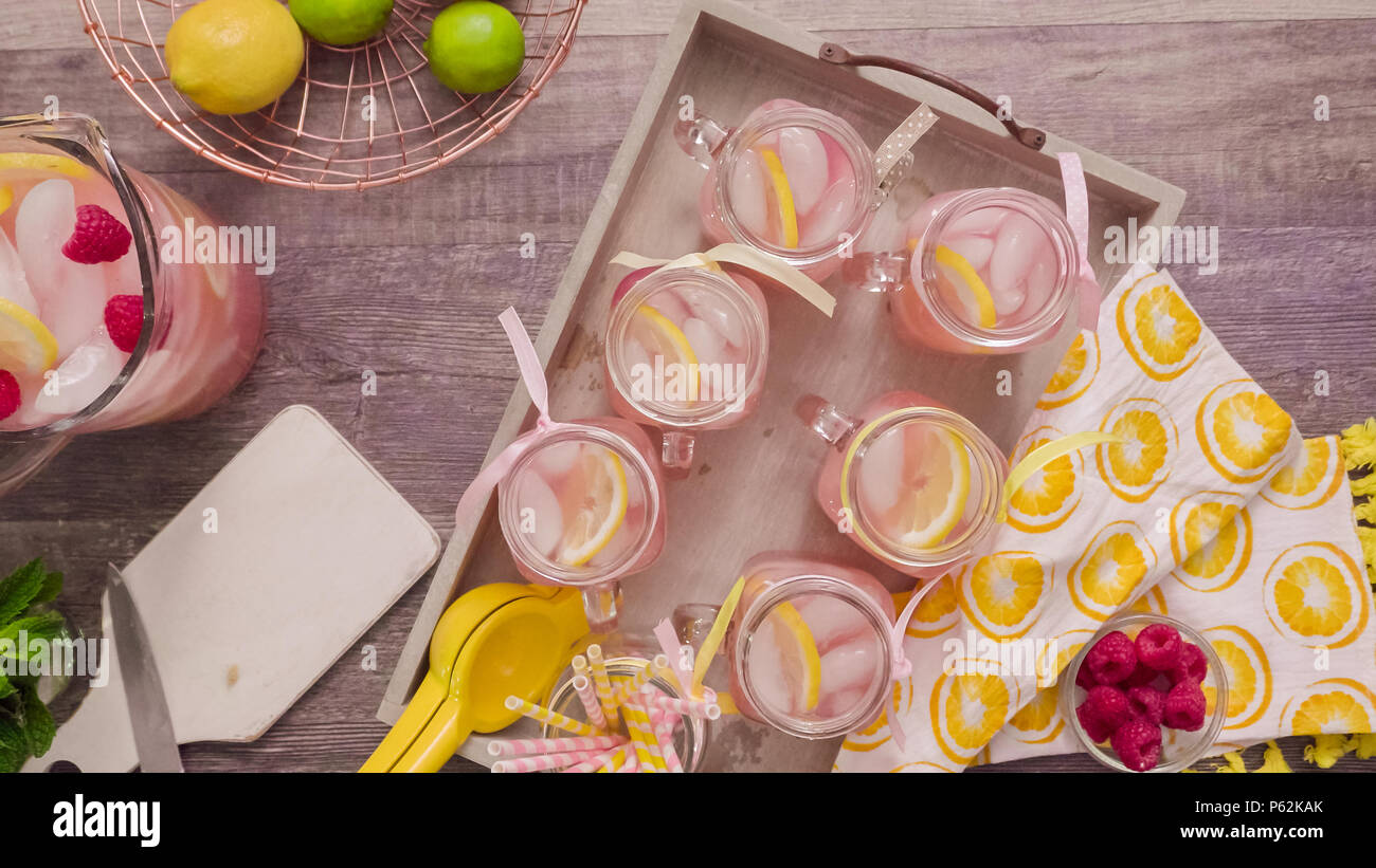 Step by step. Preparing raspberry lemonade with fresh lemons and raspberries in drinking mason ...