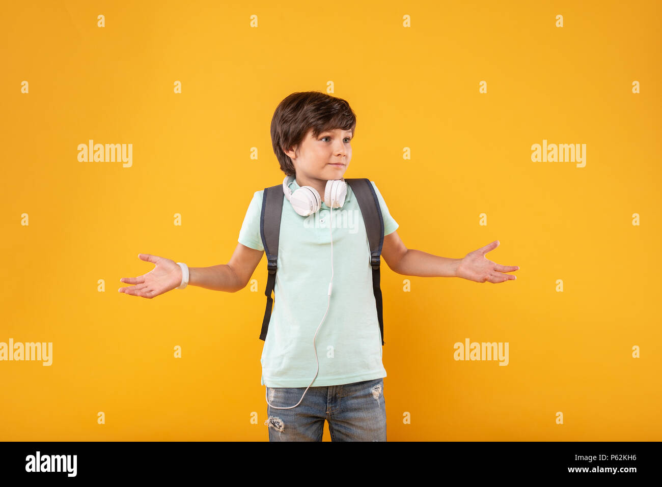 Surprised boy standing and thinking Stock Photo - Alamy