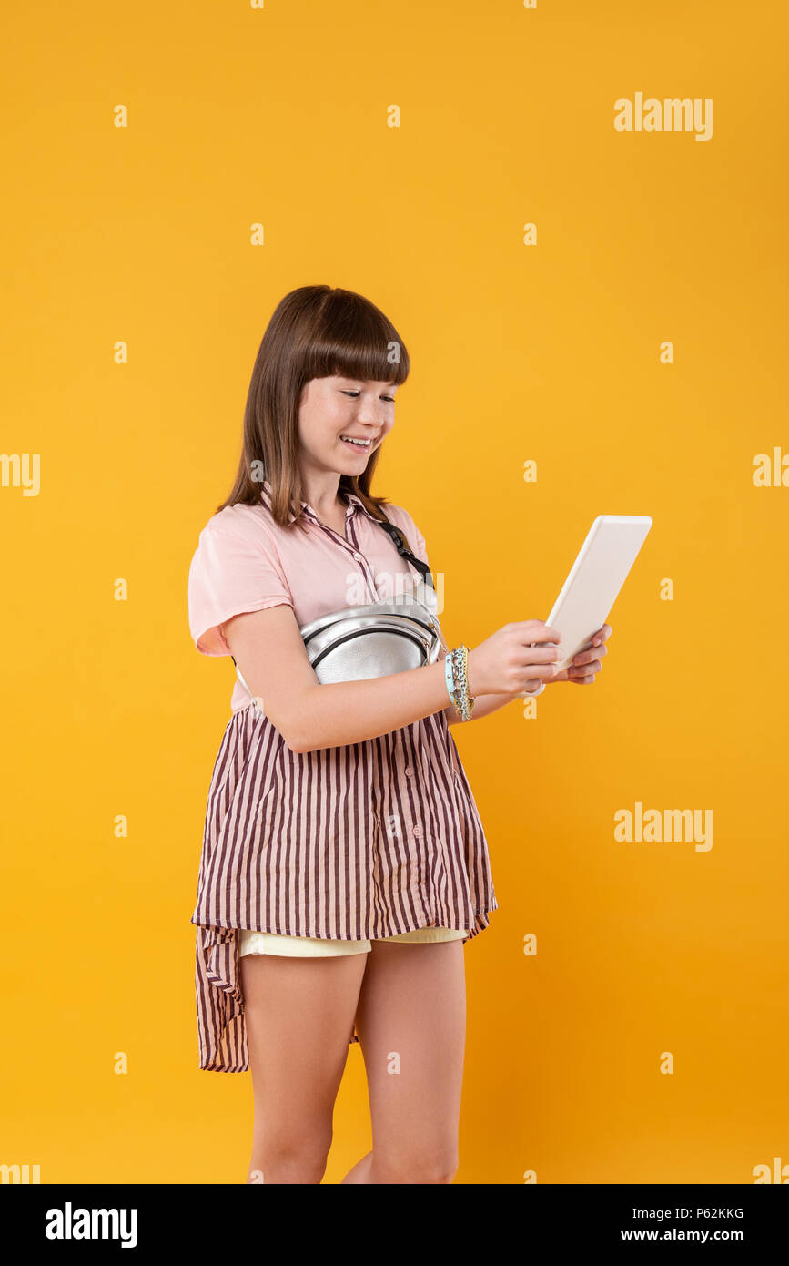 Exuberant girl holding her modern tablet Stock Photo - Alamy