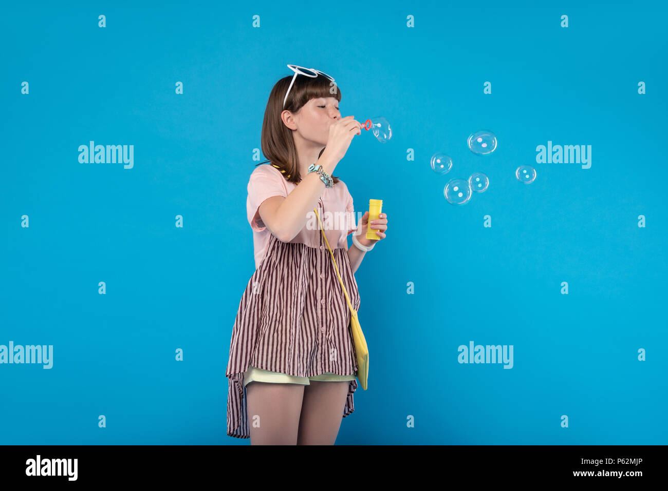 Alert girl blowing soap bubbles Stock Photo - Alamy