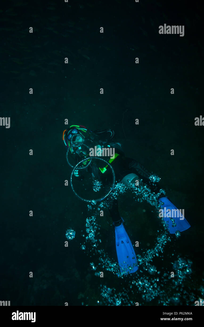 The scuba diver blows the air rings Stock Photo - Alamy