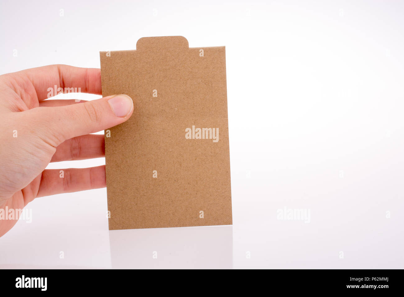 Hand holding a paper torn from a notebook Stock Photo - Alamy