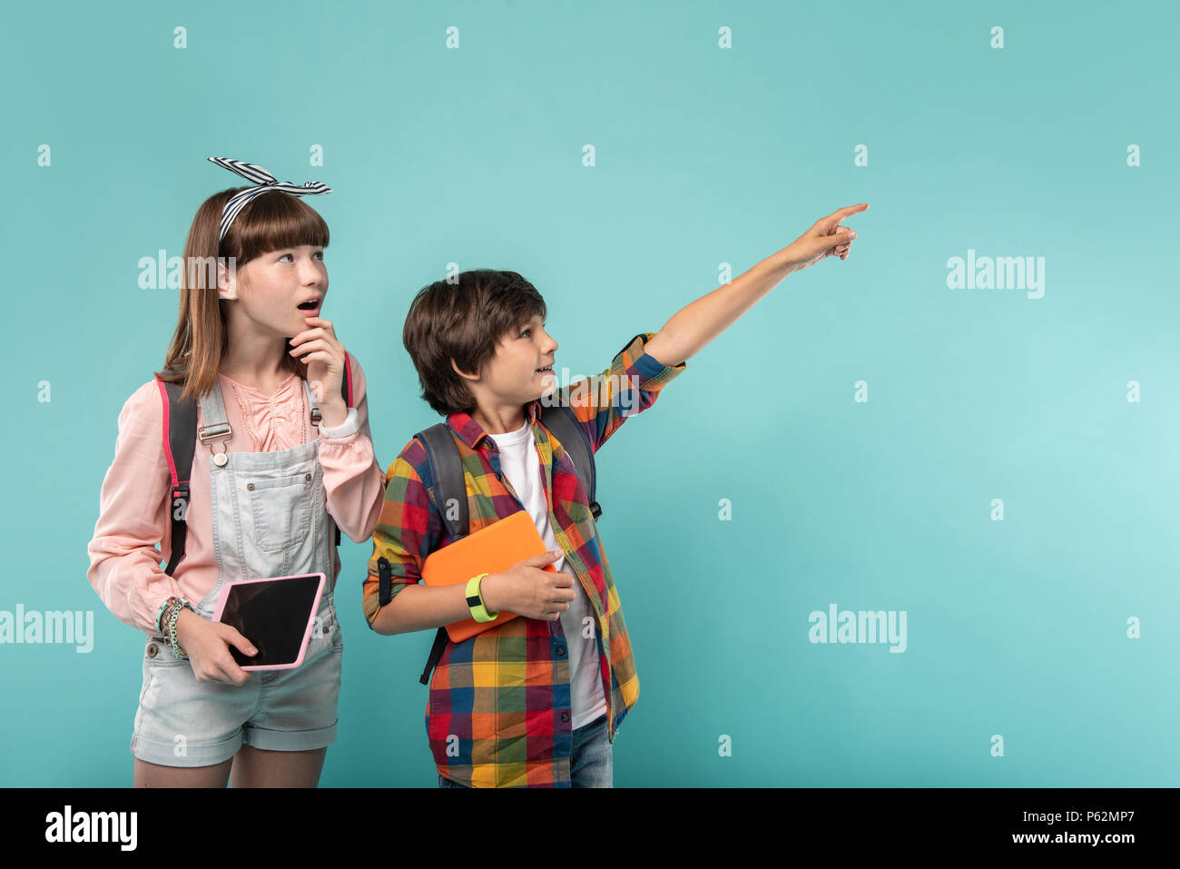 Delighted cute boy pointing at something Stock Photo - Alamy