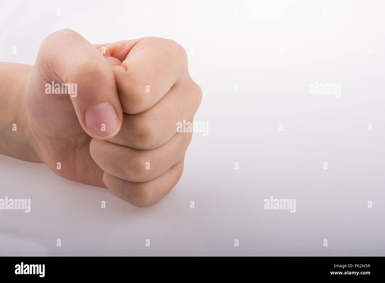 Clenched fist on a white background Stock Photo - Alamy