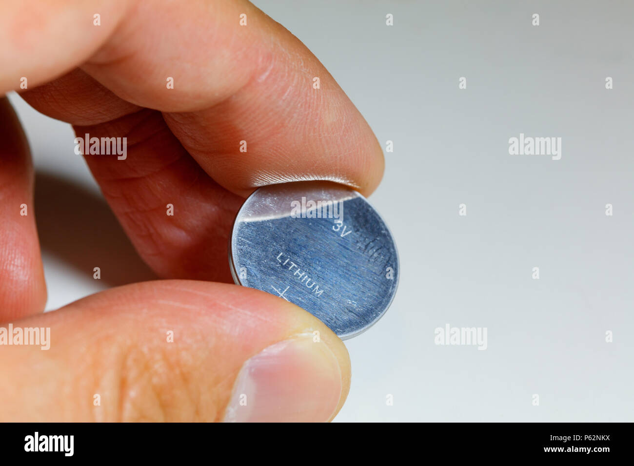 Silver Button Cell Battery On White Background Stock Photo - Alamy