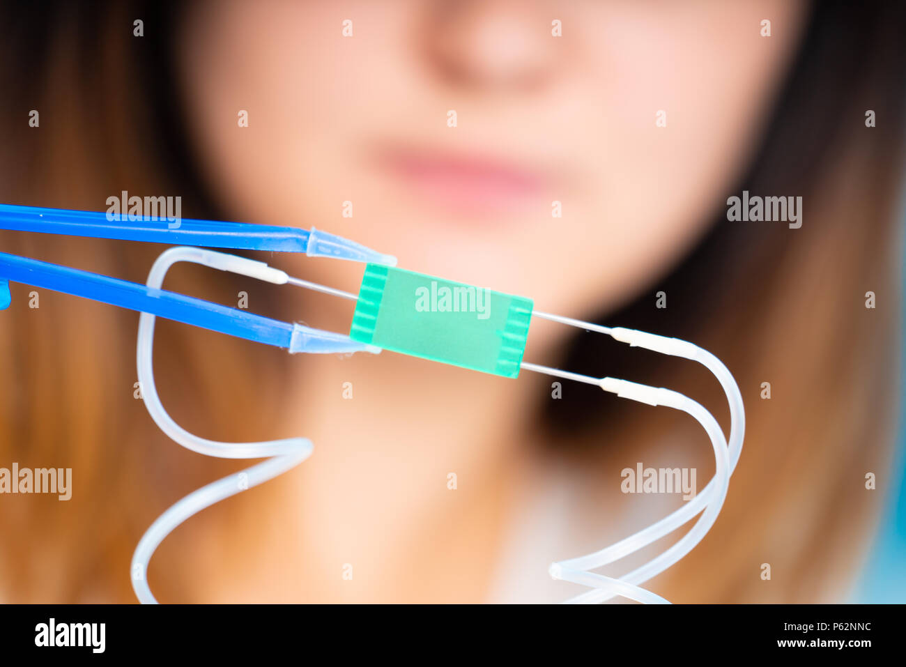 technician girl with microfluidic device LOC in microbiological lab ...