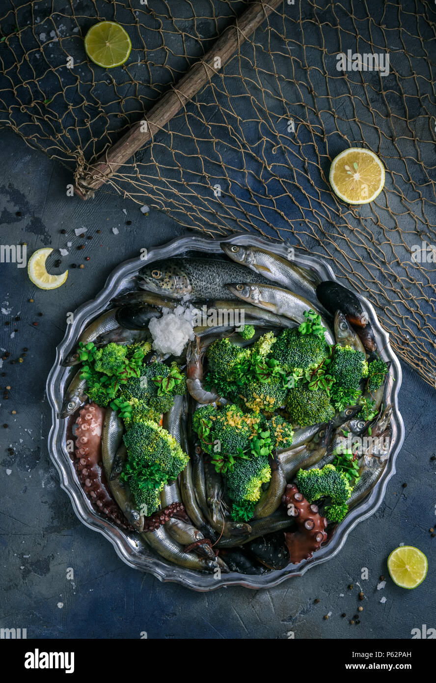 Raw Mixed seafood on a silver plate, dark background, copyspace Stock ...