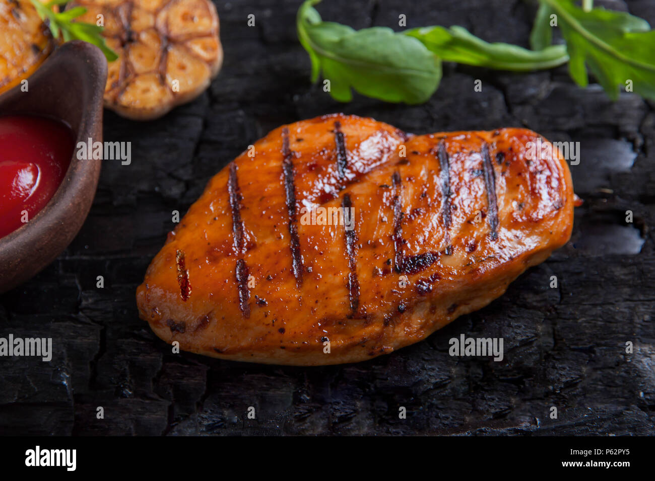 Grilled chicken fillet with sauce,garlic and lemon on wood Stock Photo ...