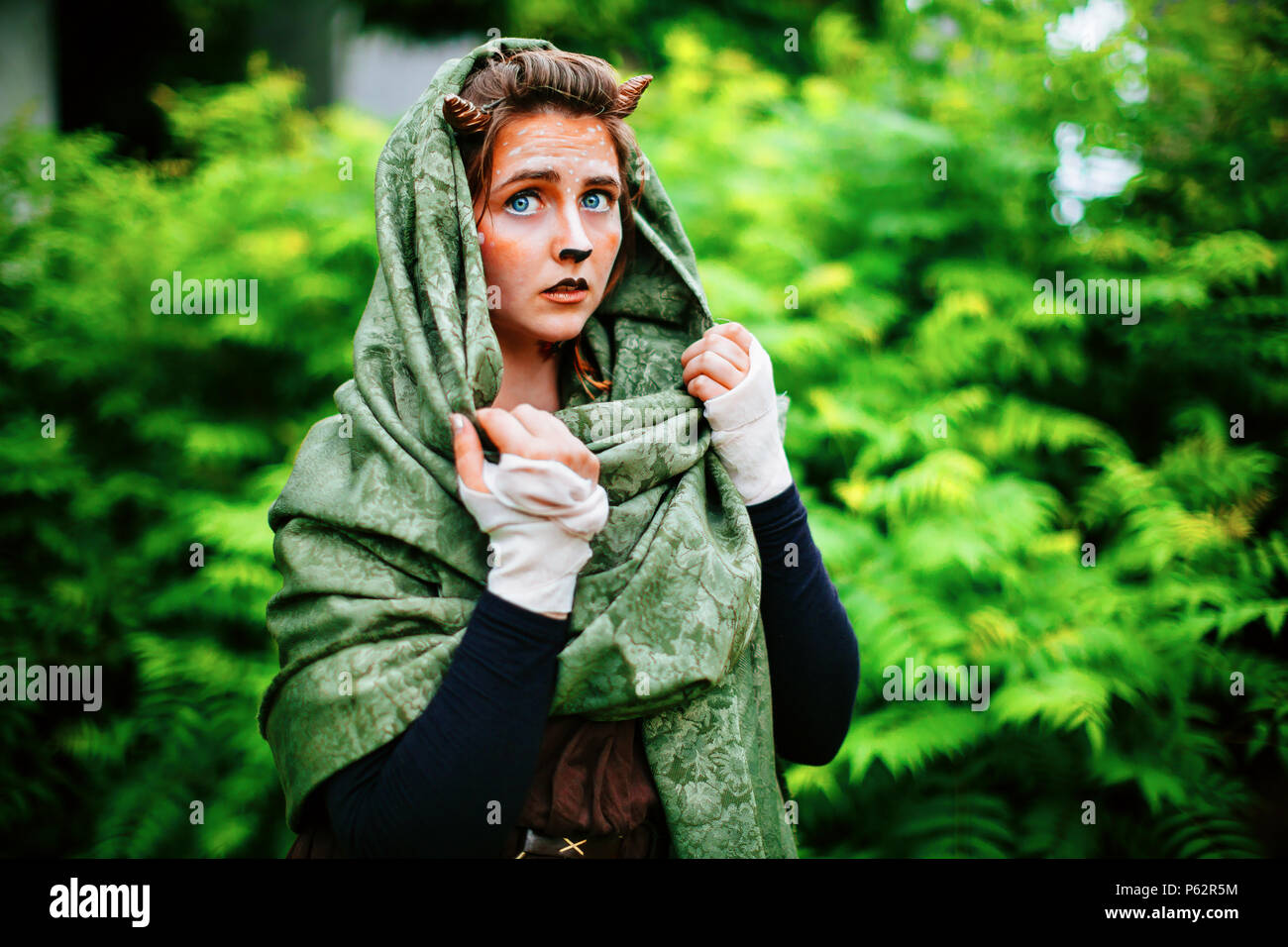 A Renaissance fair actor dressed in costume as a woodland creature ...
