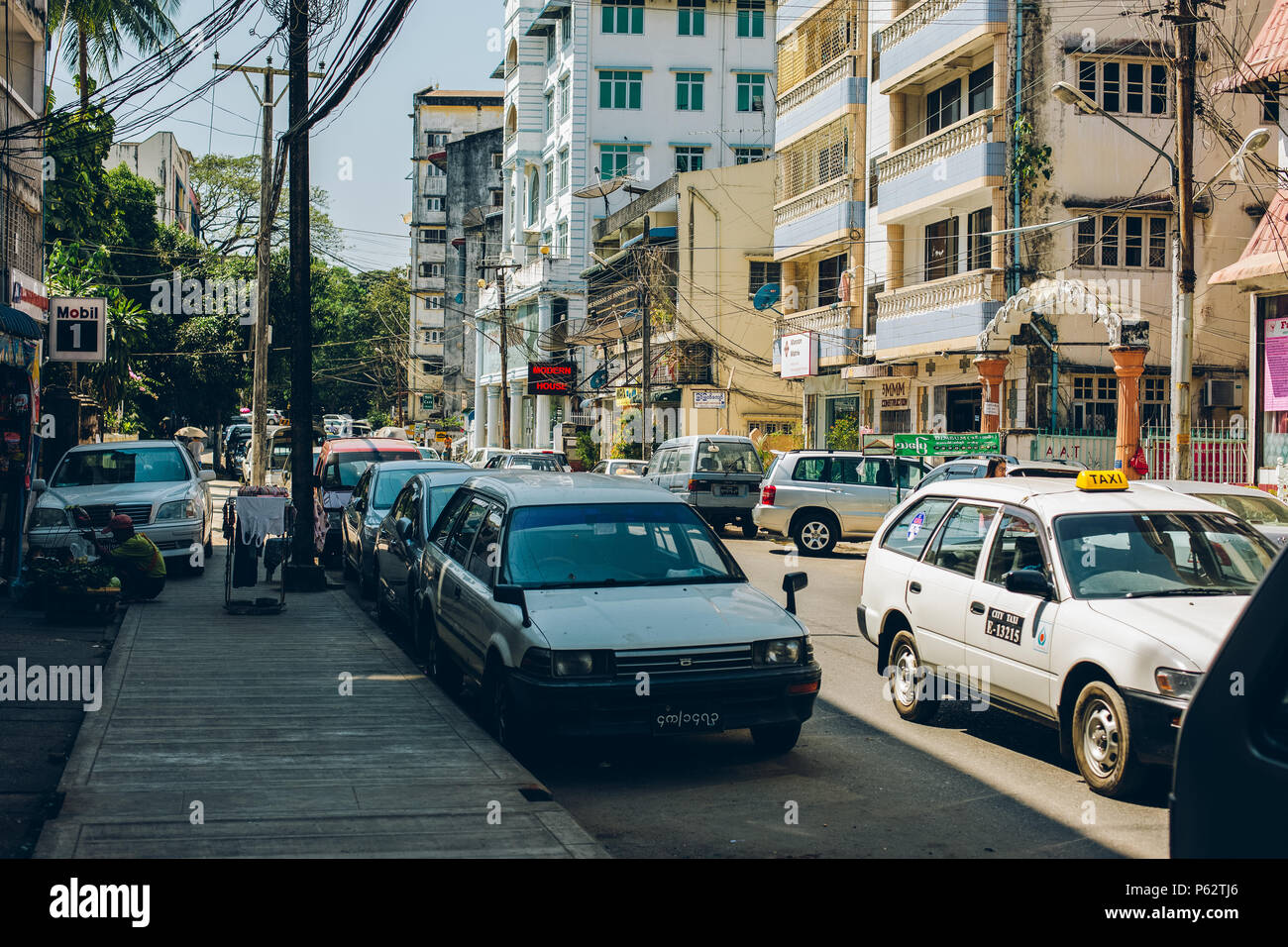 Yangon, Myanmar - FEB 19th 2014: Street view of taxi and cars on the ...