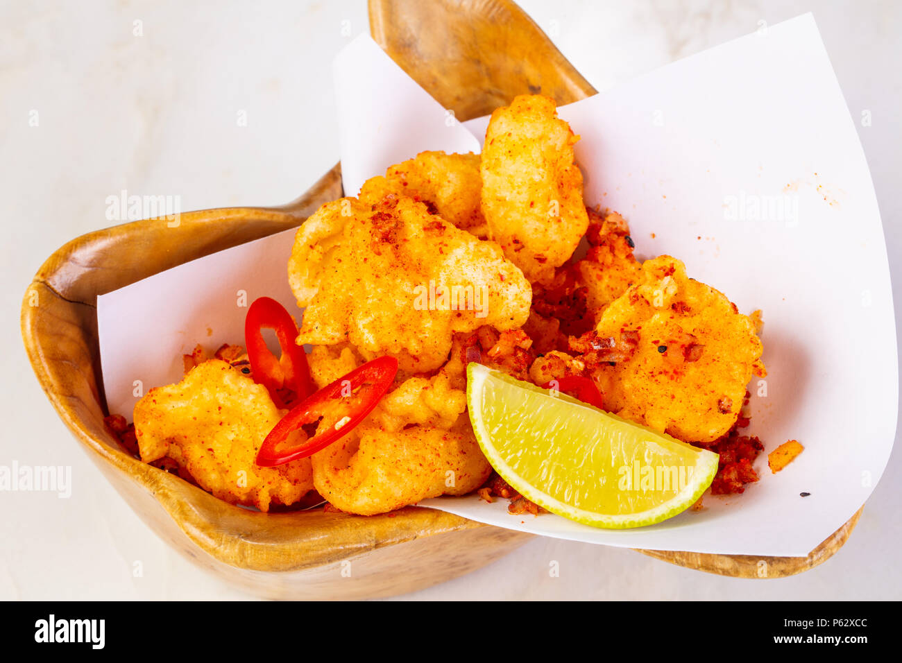 Crispy squid with chili and lemon Stock Photo - Alamy