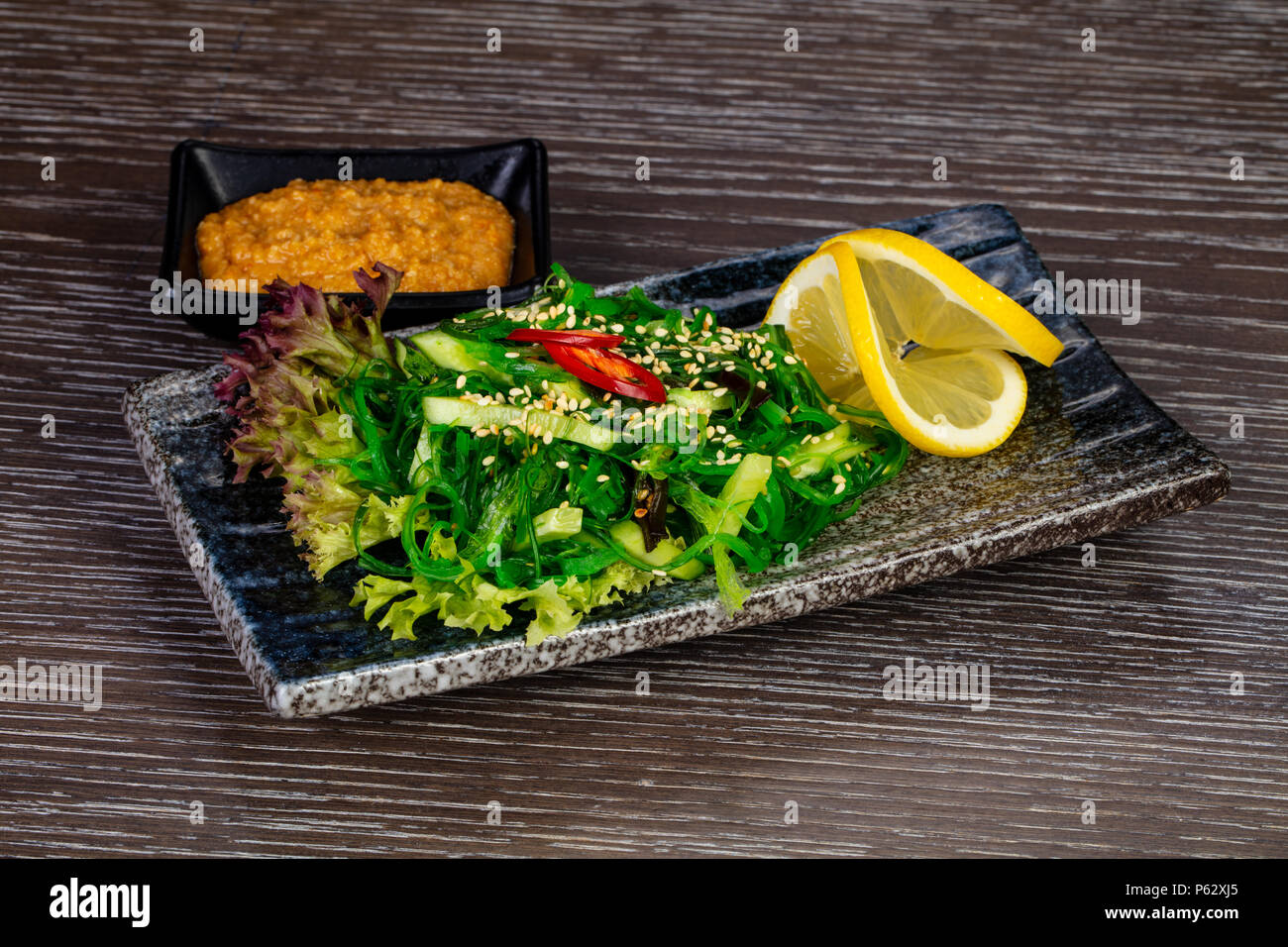 Bright green kaiso salad with lemon Stock Photo - Alamy