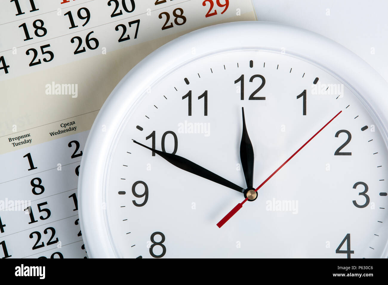 sheet of a calendar with the number of days and clock Stock Photo - Alamy