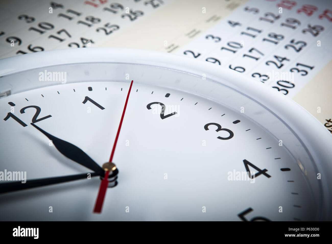 sheet of a calendar with the number of days and clock Stock Photo - Alamy