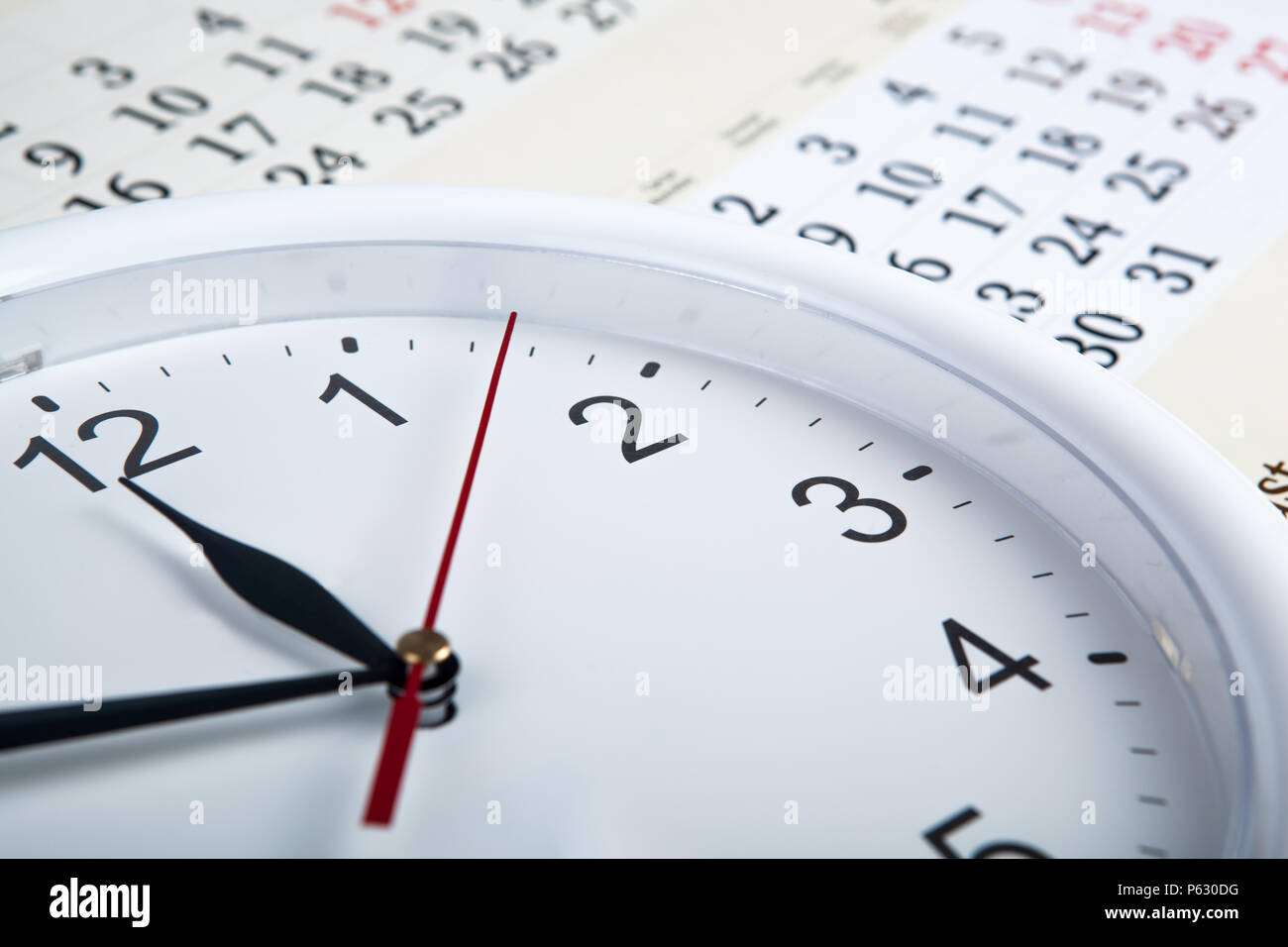 sheet of a calendar with the number of days and clock Stock Photo - Alamy