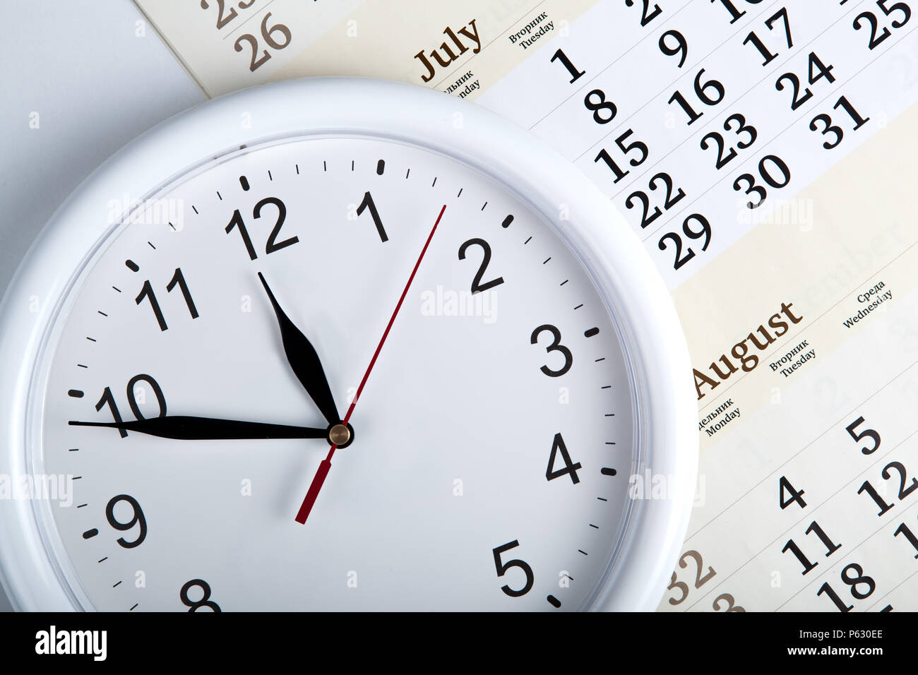 sheet of a calendar with the number of days and clock Stock Photo - Alamy