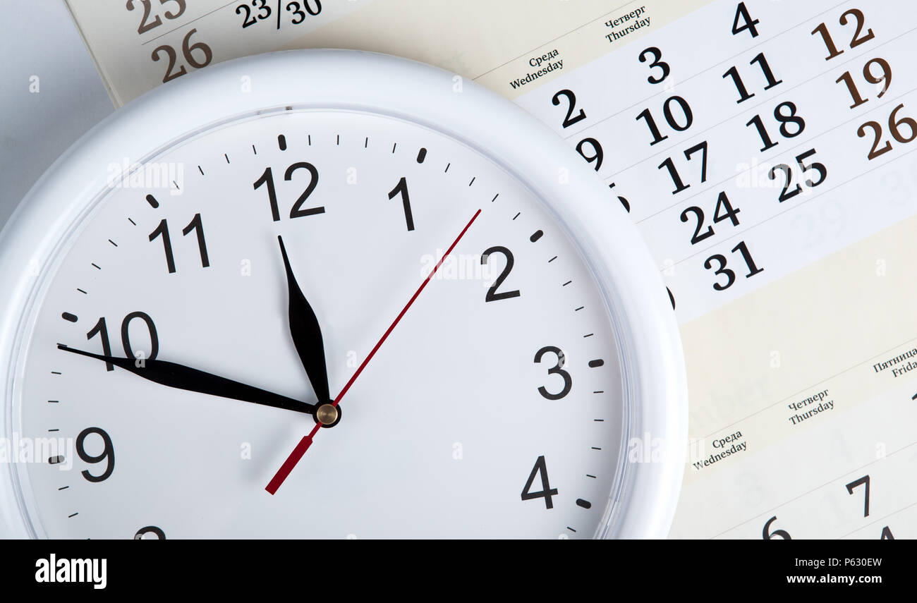sheet of a calendar with the number of days and clock Stock Photo - Alamy