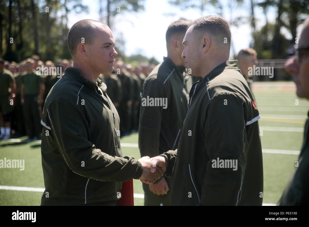 Sgt. Benjamin D. Patrick (left)shakes hands with Lt. Col. Anthony J ...