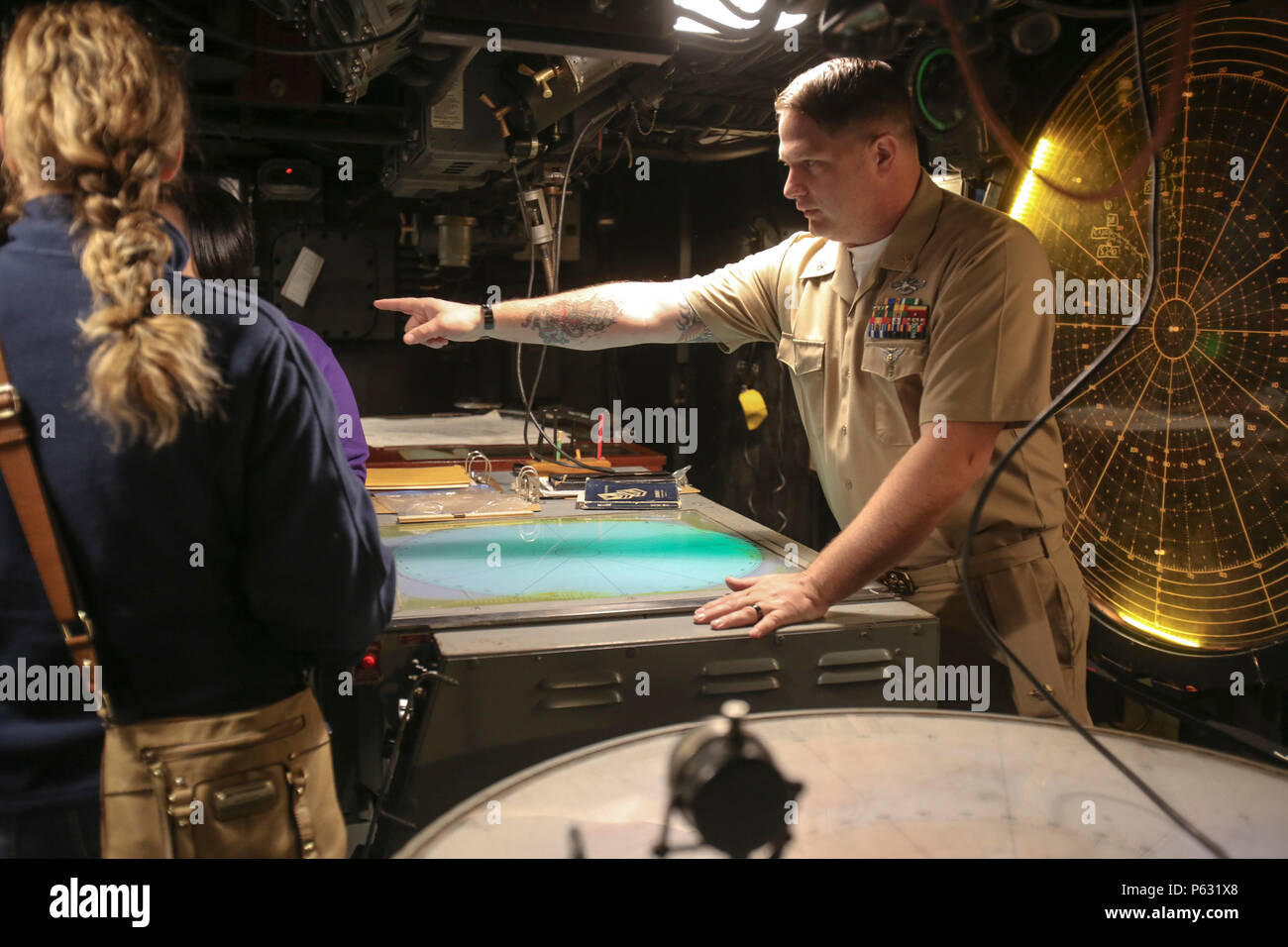 Chief Petty Officer Jeremy Moore explains to visitors the various ...