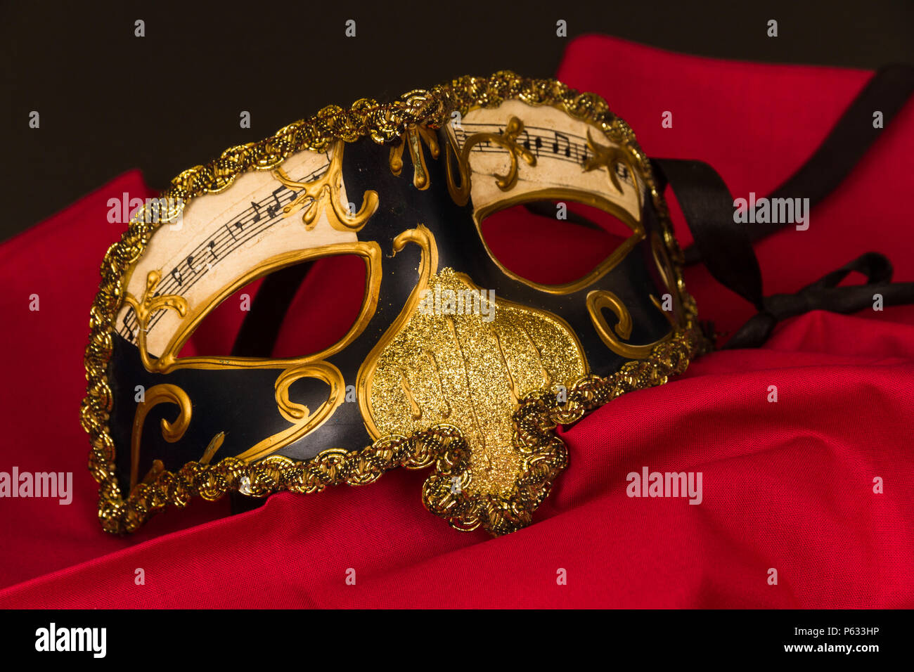 Venetian mask on red material with black background and copyspace Stock ...