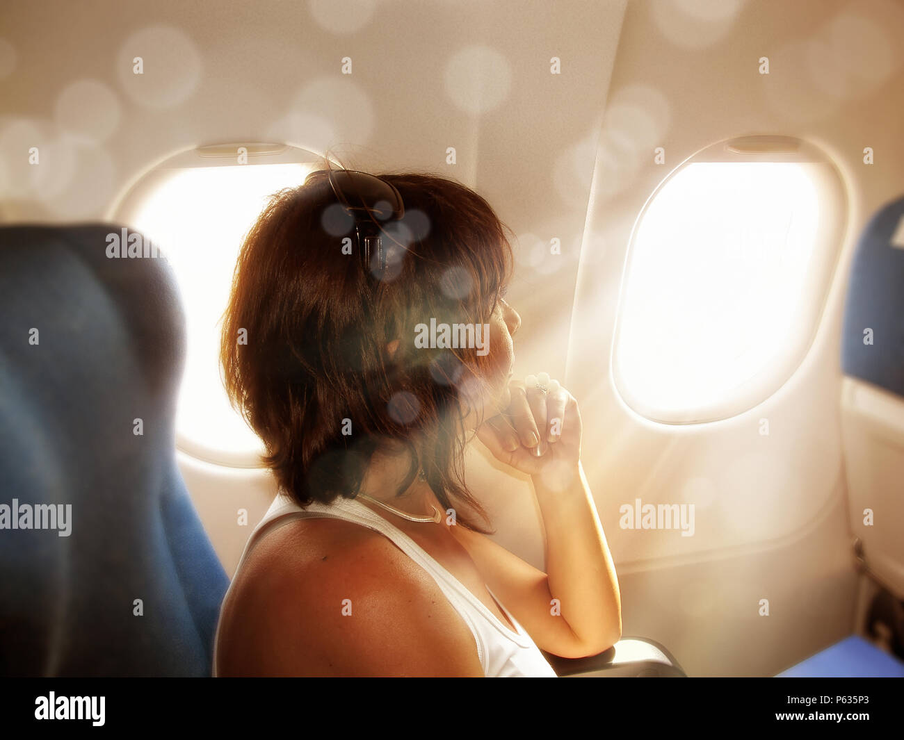 an image of a woman looking from airplane window Stock Photo - Alamy