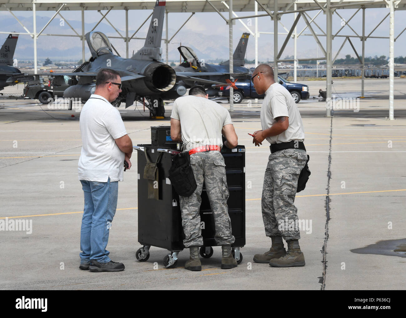 Tim Fournier (left), an F-16 Fighting Falcon weapons standardization ...
