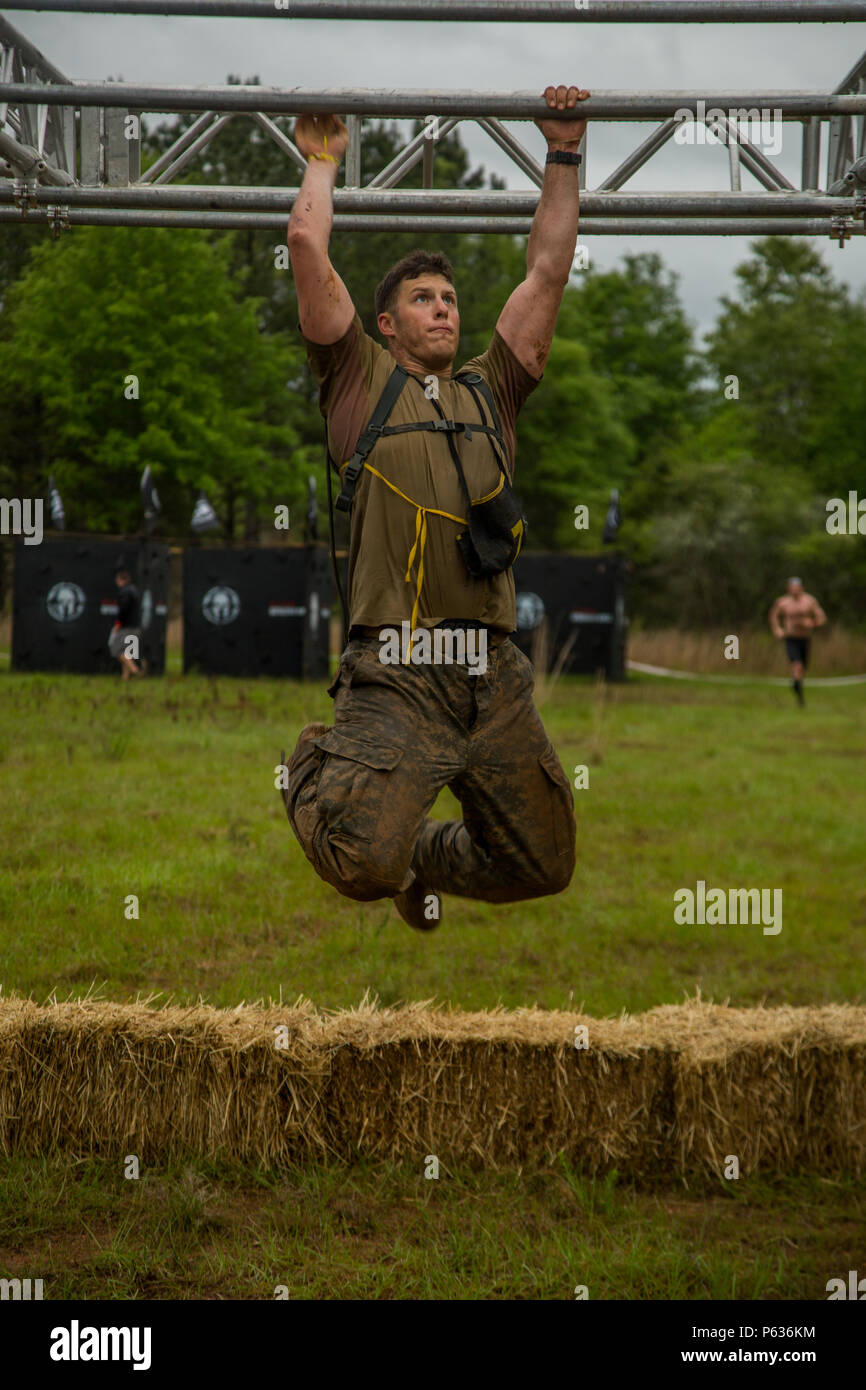 A U.S. Army Soldier negotiates his way through the monkey bars obstacle ...
