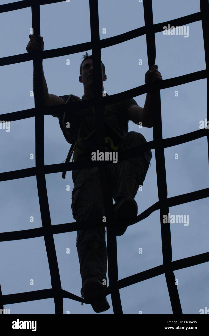 U.S. Army Ranger climbs a cargo net obstacle during a Spartan Race as ...