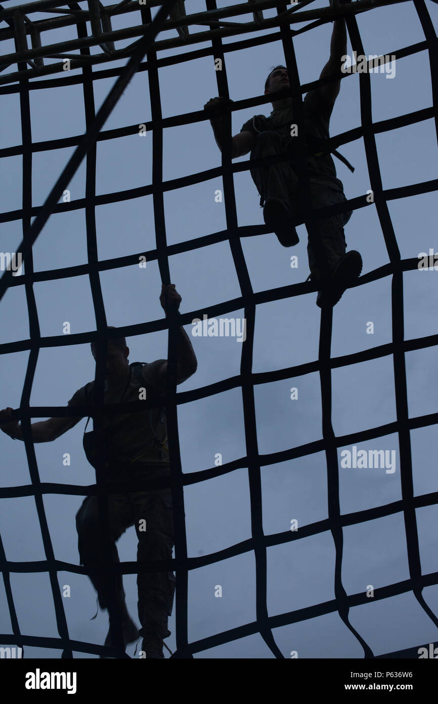 U.S. Army Rangers climb a cargo net obstacle during a Spartan Race as ...